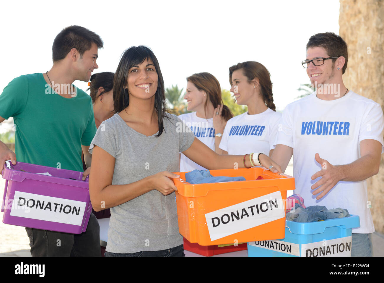 Charity: Happy group of volunteers collecting clothing donations Stock ...