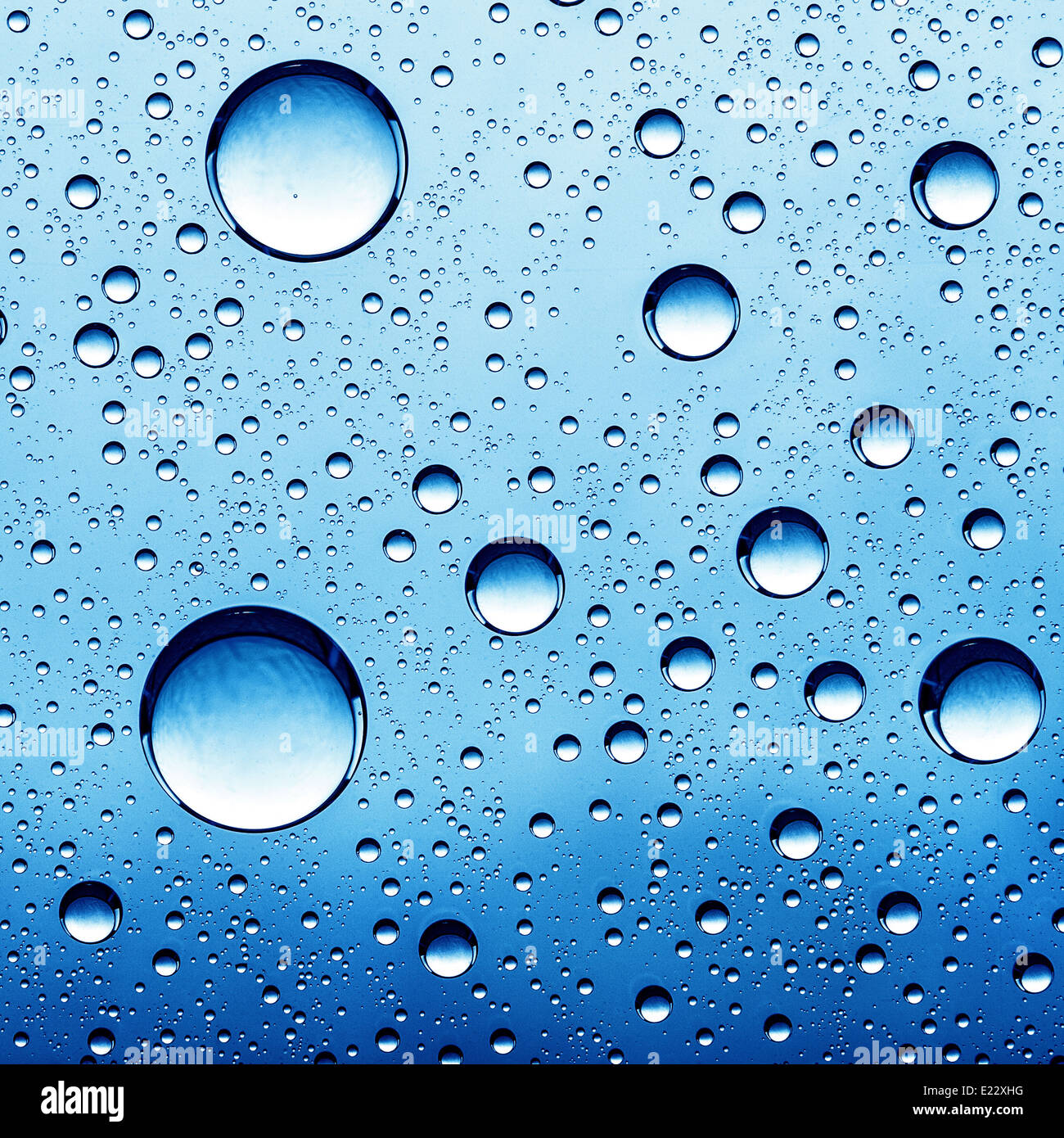 Pure oil drops over glass surface as abstract backgrounds Stock Photo ...