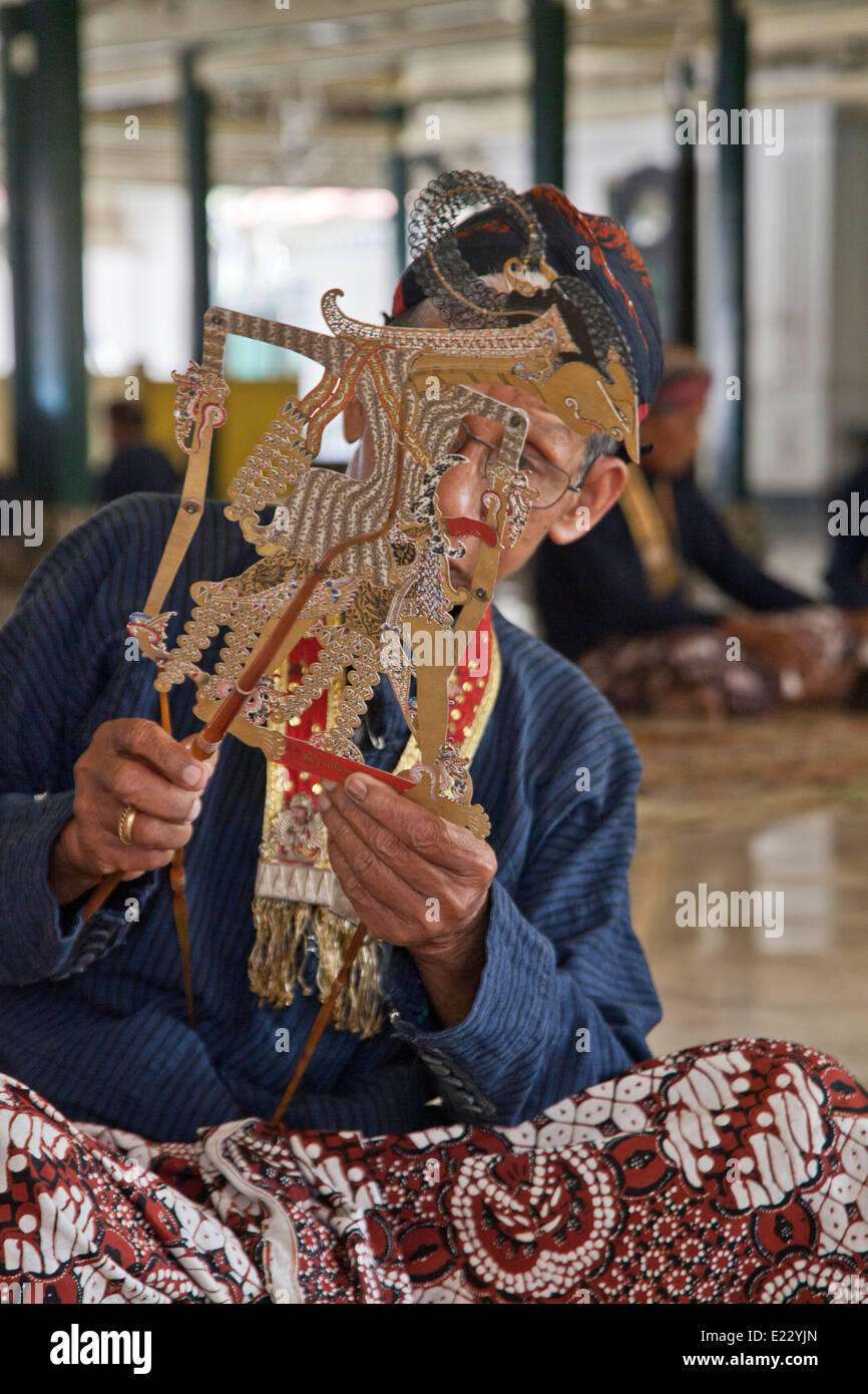Master craftsman inspects the traditional leather puppet before the ...