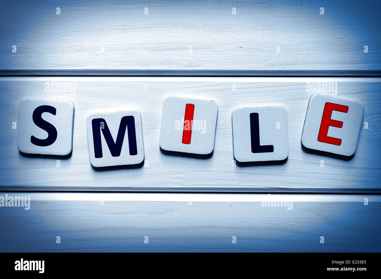Smile word composed of letters on a background of wood Stock Photo - Alamy