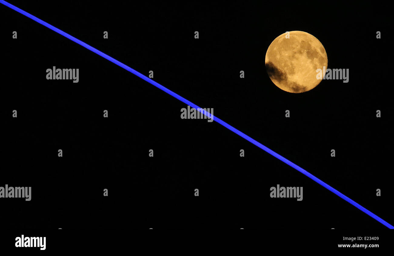 Leipzig, Germany. 13th June, 2014. A full moon is pictured above a blue ...