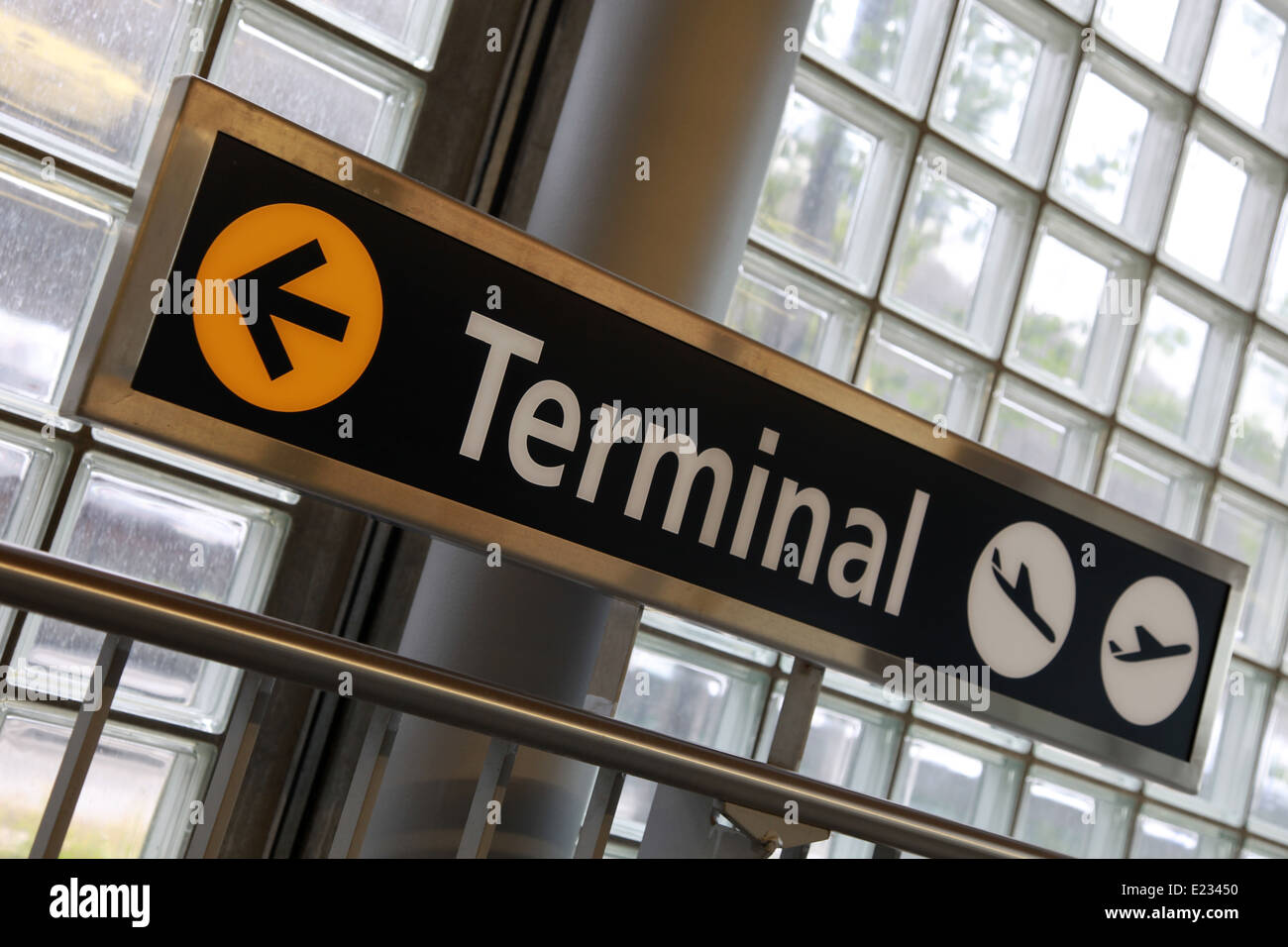 Sign in an airport building showing the way to the terminal building ...
