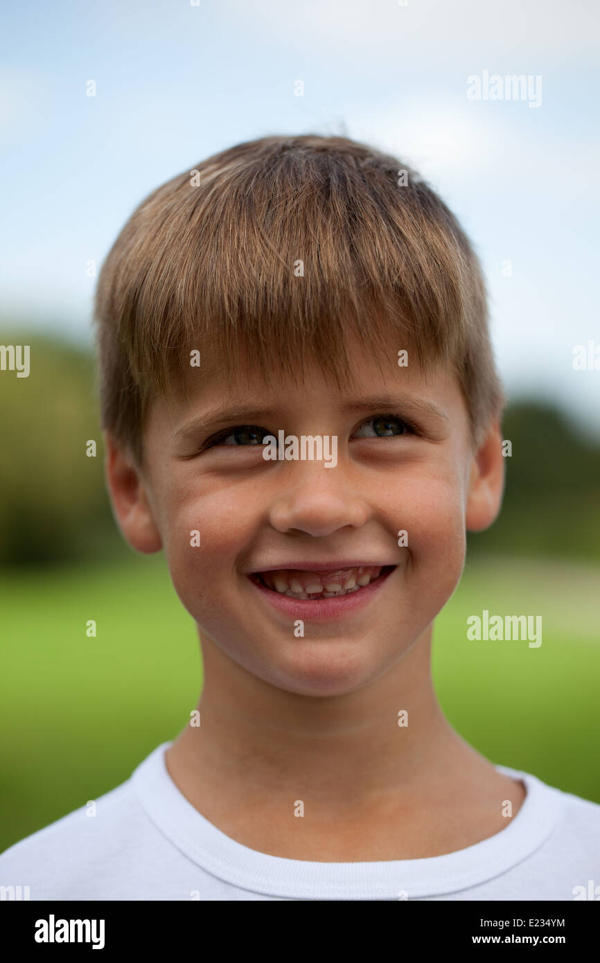 Portrait of a happy smiling young boy looking up Stock Photo - Alamy