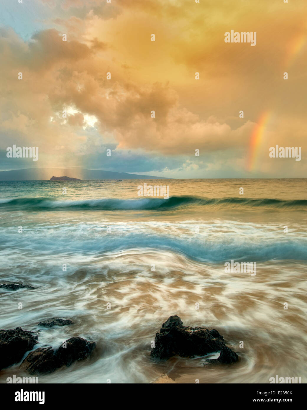 Maui coast with waves and rainbow with light and rain on Molokini ...