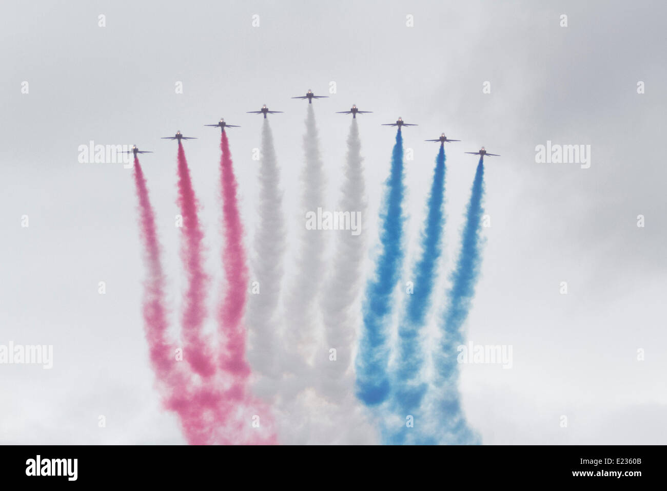 London UK. 14th June 2014. Red Arrows perform a flypast over Buckingham ...