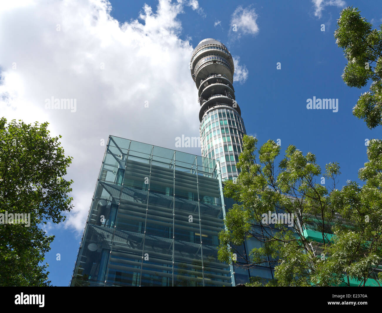Telecom Tower against a blue sky with white clouds and trees Stock ...
