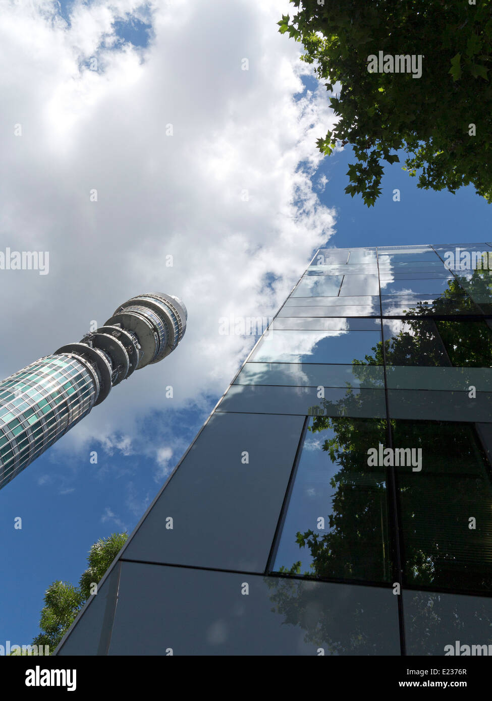 Telecom Tower against a blue sky with white clouds and trees Stock ...