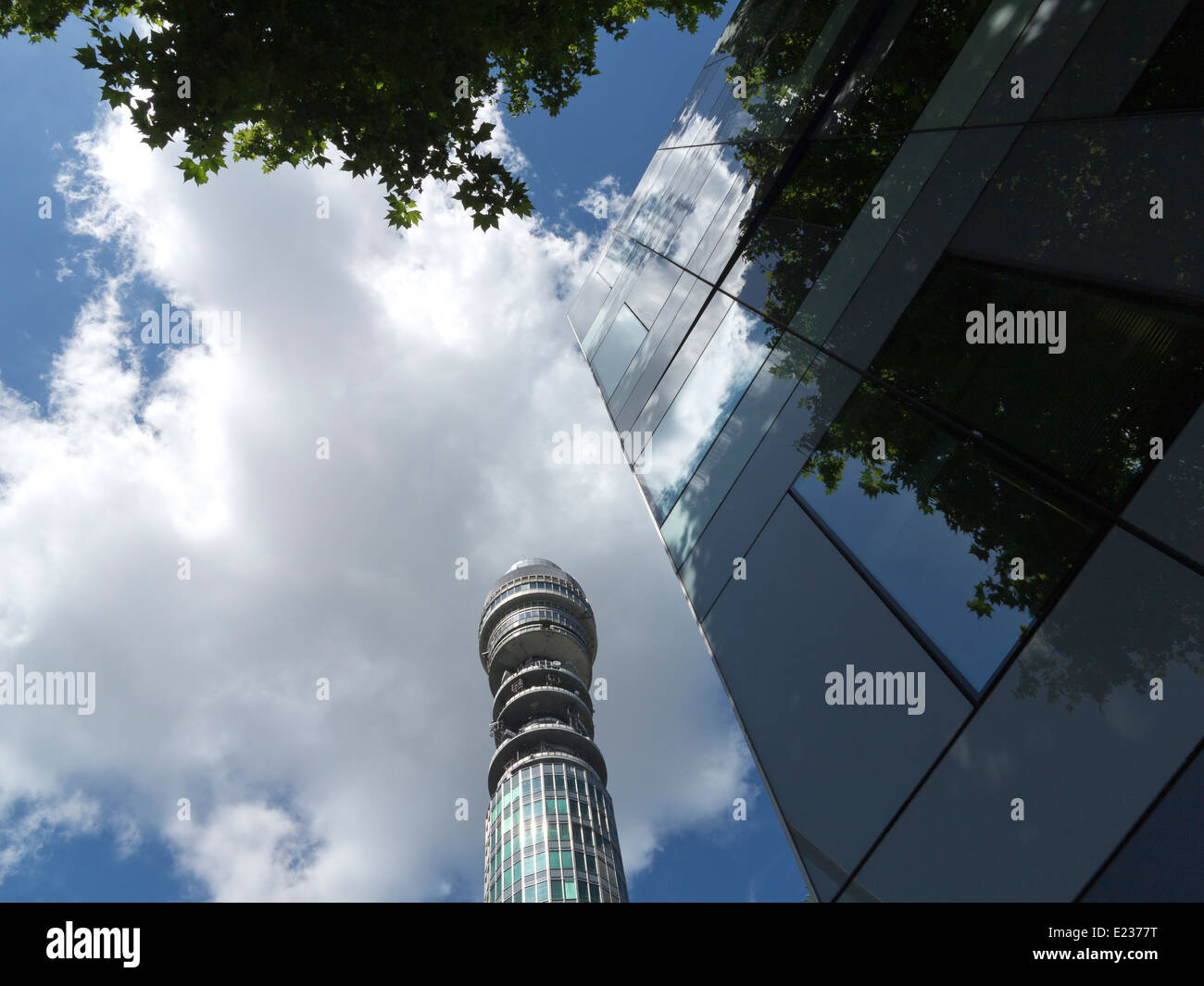 Telecom Tower against a blue sky with white clouds and trees Stock ...