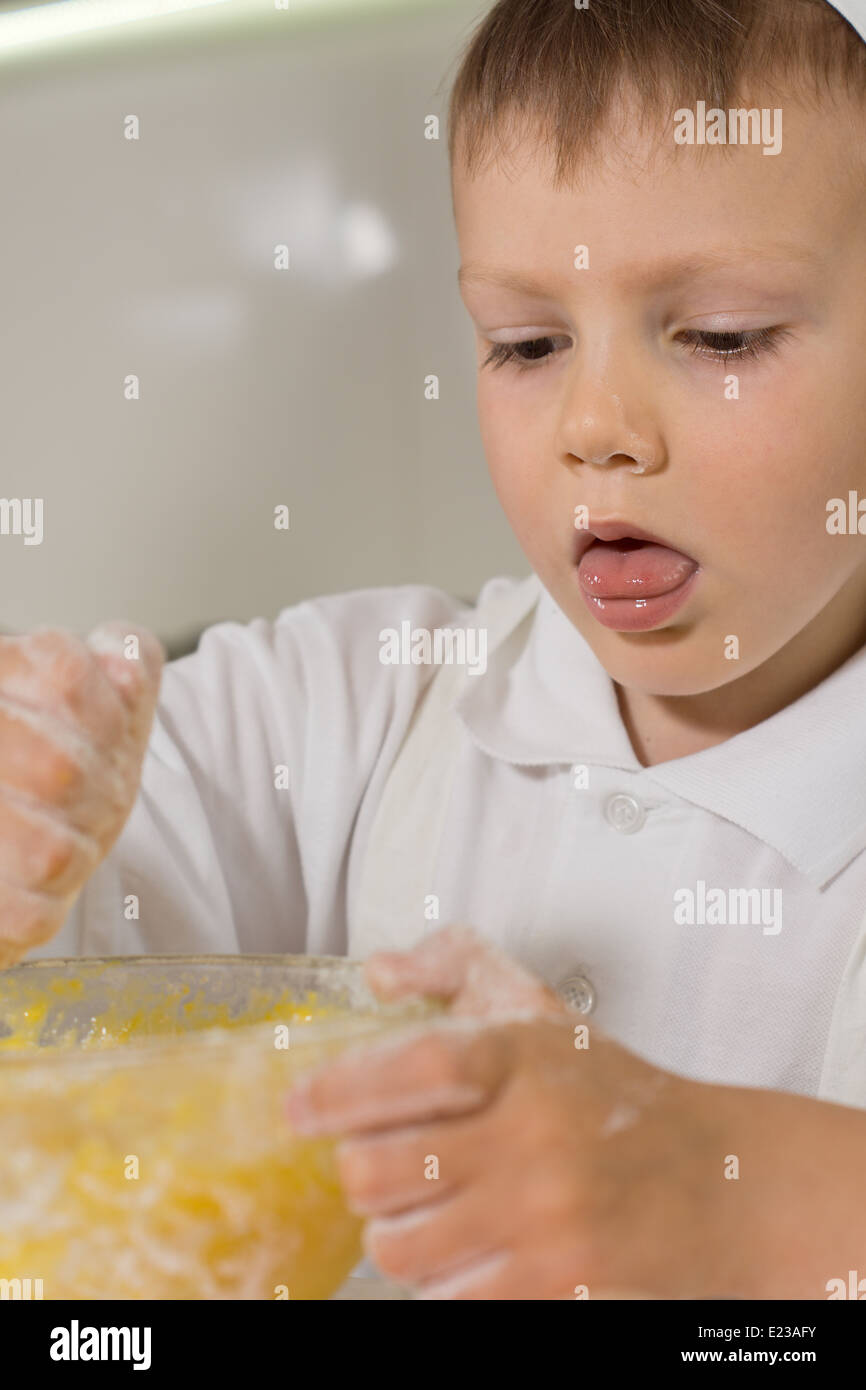 Child mixing flour and eggs hi-res stock photography and images - Alamy
