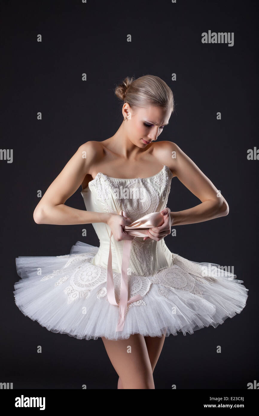 Concentrated pretty ballet dancer kneads pointe Stock Photo - Alamy