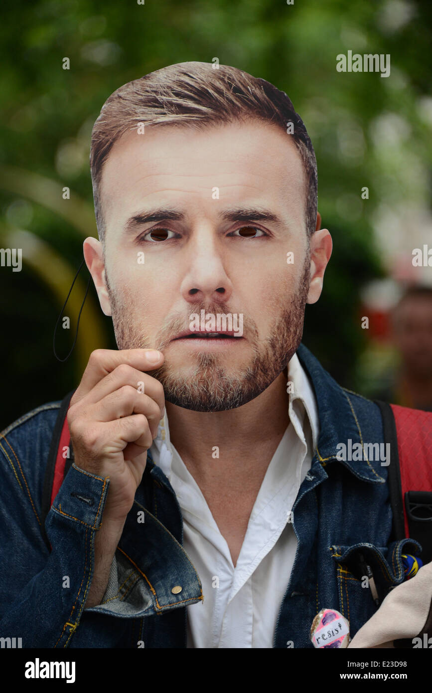 London, UK, 14th June, 2014. A protester wearing Gary Barlow a mask ...