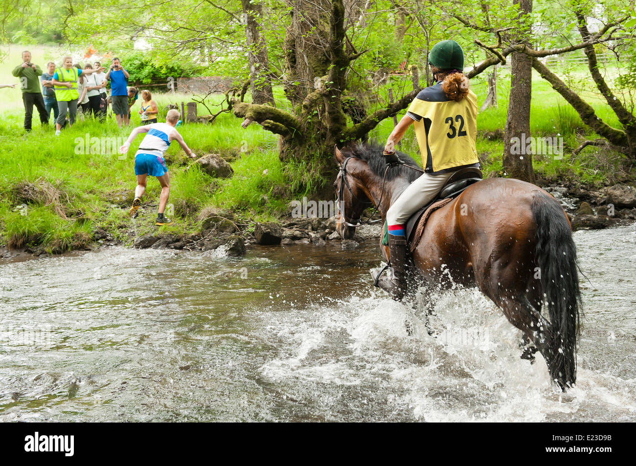Llanwrtyd Wells, UK. 14th June 2014. Runners & horses compete in the 23 ...
