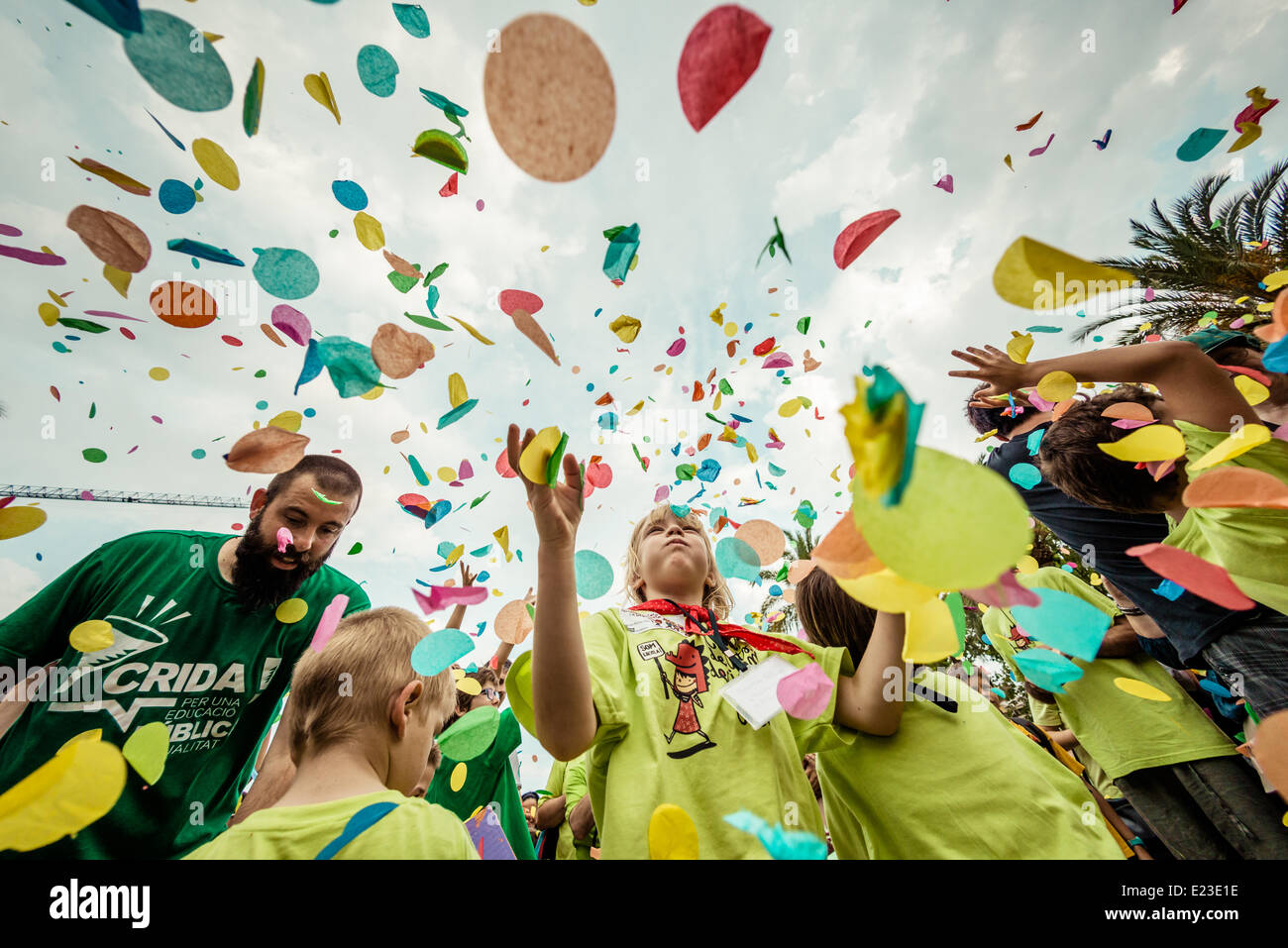 Barcelona, Spain. June 14th, 2014: Children have fun throwing confetti ...