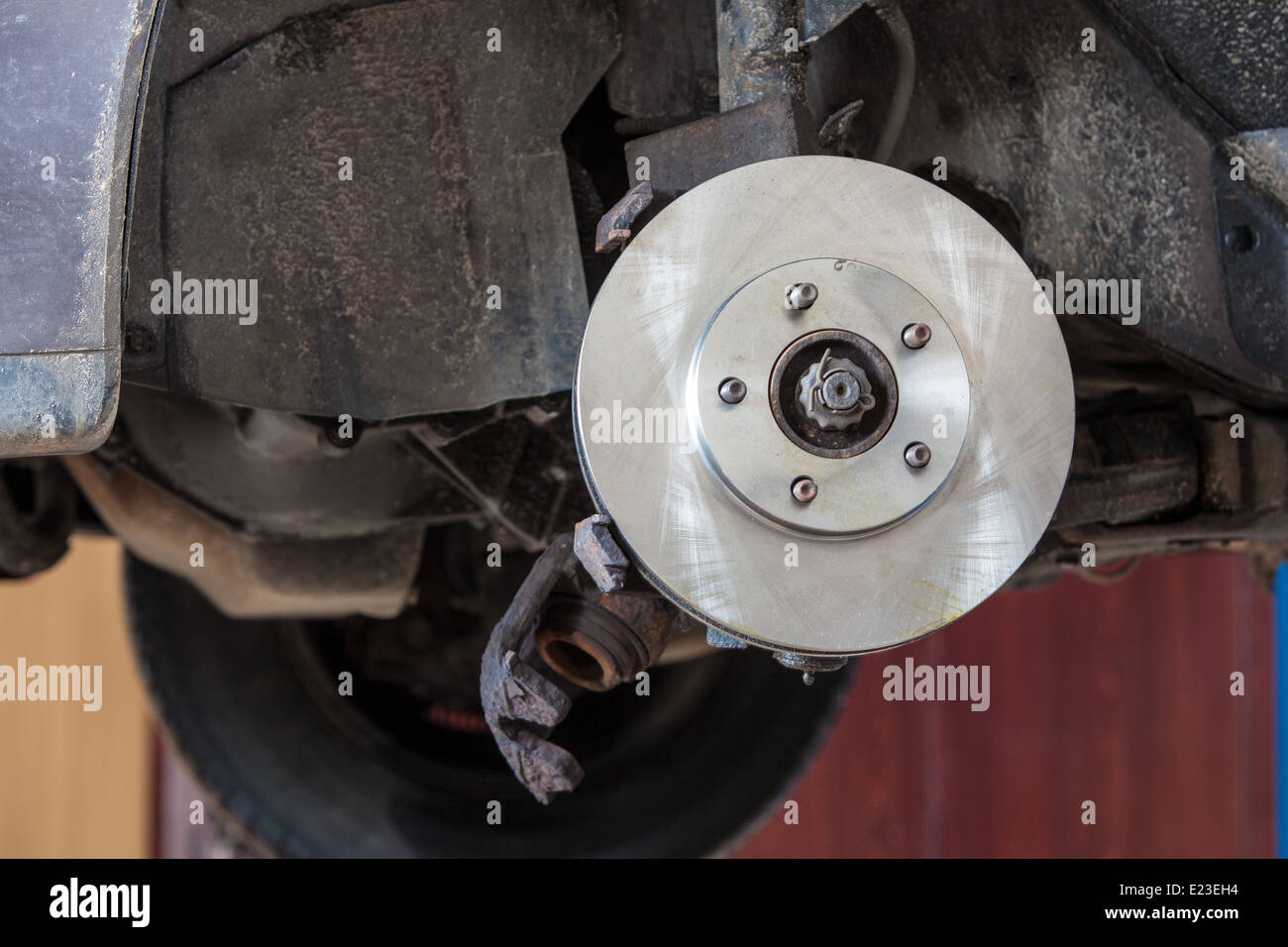 Car in service repairing. Closeup detail of the wheel assembly on ...