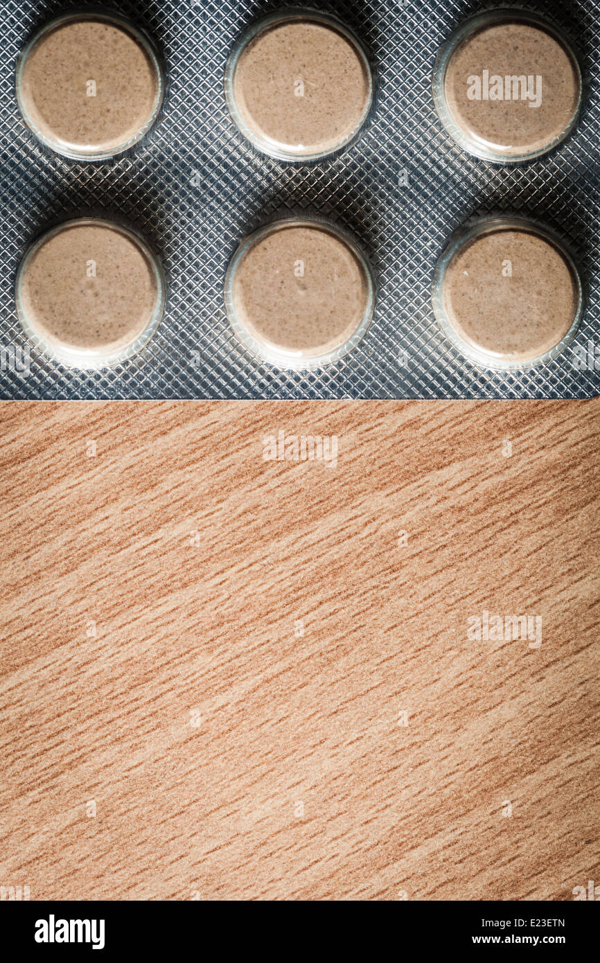 Medical background backdrop with pills tablets drugs on wooden table ...