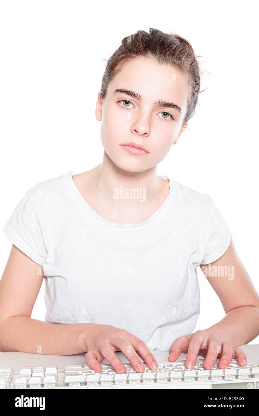 serious teenager girl working on a keyboard, isolated on white Stock ...