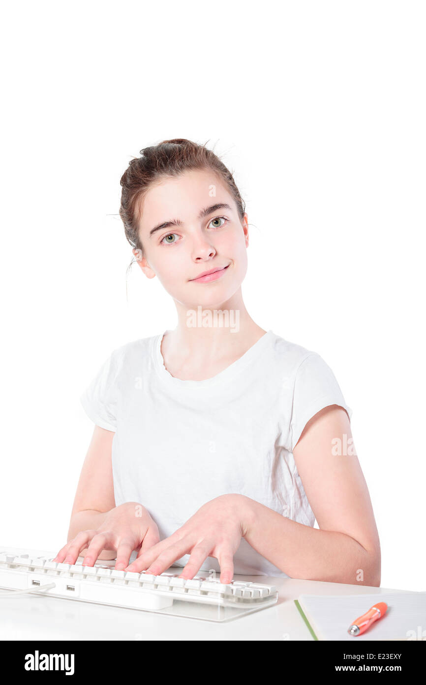smiling teenager girl working on a keyboard, isolated on white Stock ...
