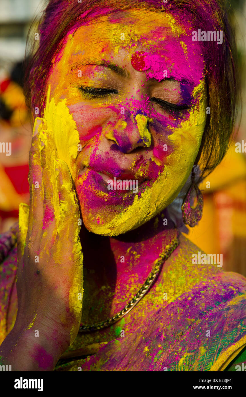 Portrait of an Indian woman with colors in her face at Holi festival ...