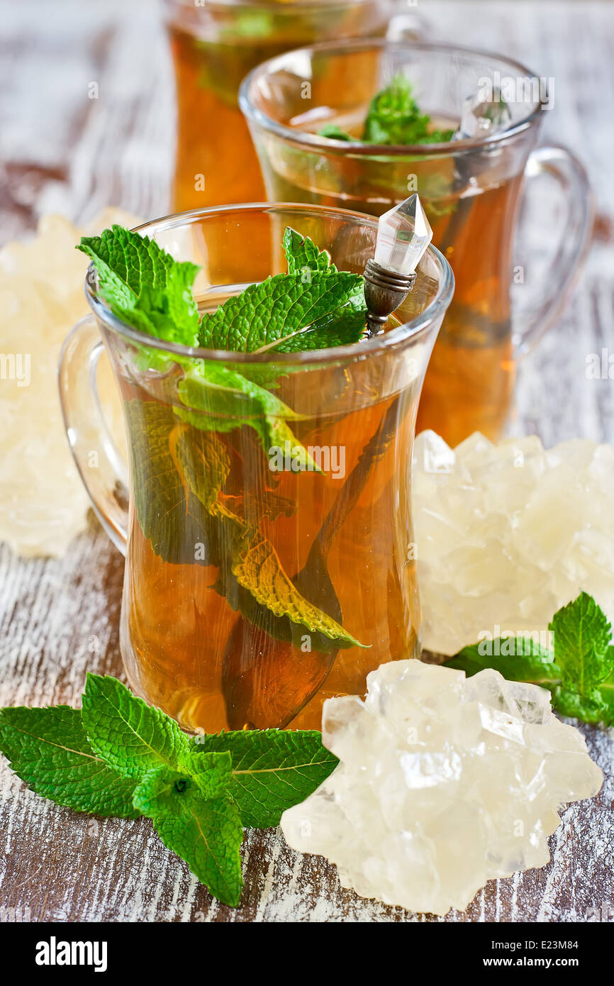 Traditional turkish tea with fresh mint and light brown rock sugar or ...