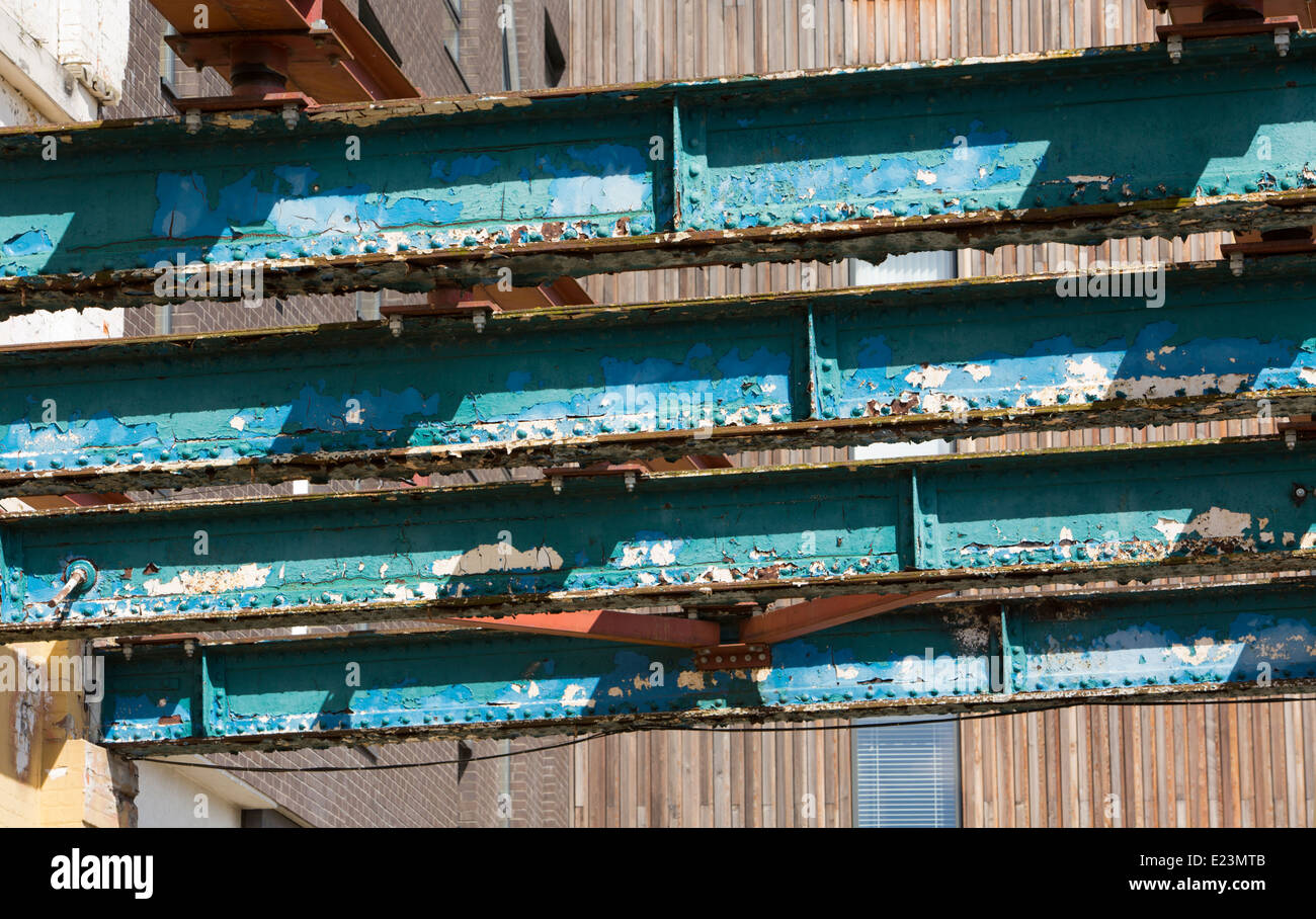 painted rusted flaking heavy metal load bearing girders on construction ...