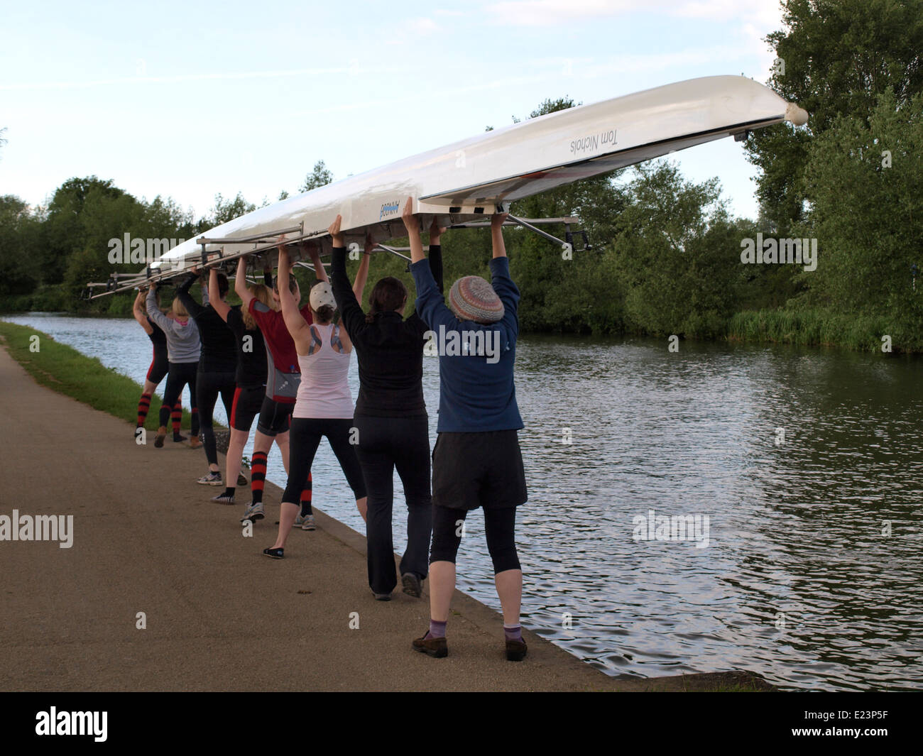 Sculling boat crew putting boat into the River Thames near Oxford, UK ...