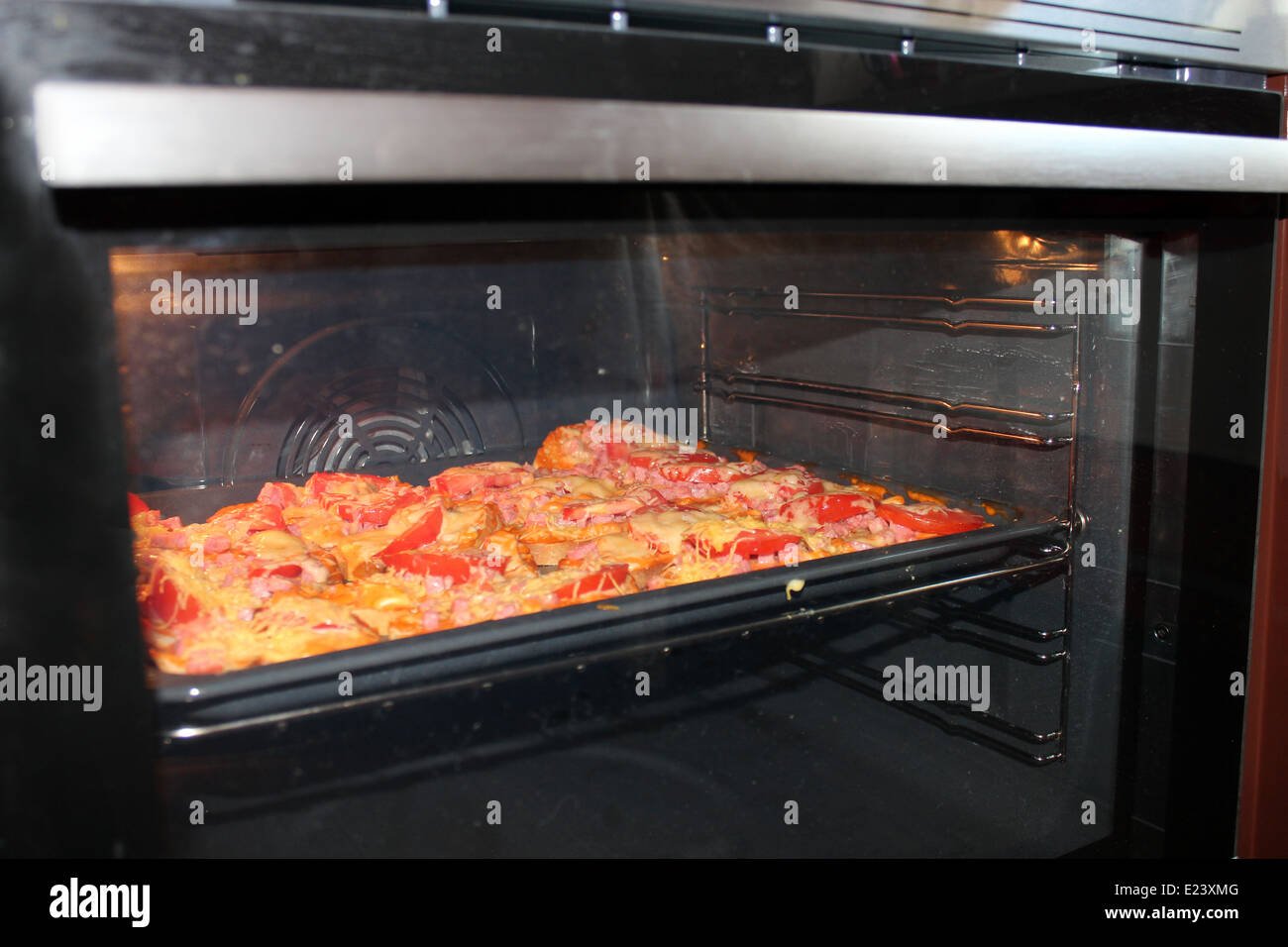 hot sandwiches with sausage and melted cheese cooking in the kitchen ...
