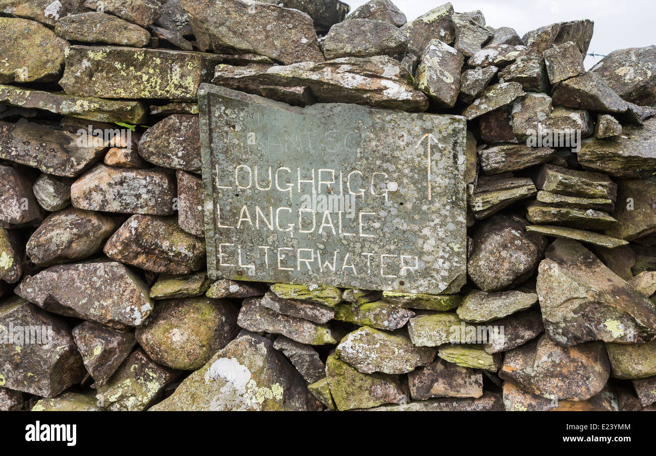 Slate sign for walkers in a drystone wall at Loughrigg Fell near ...