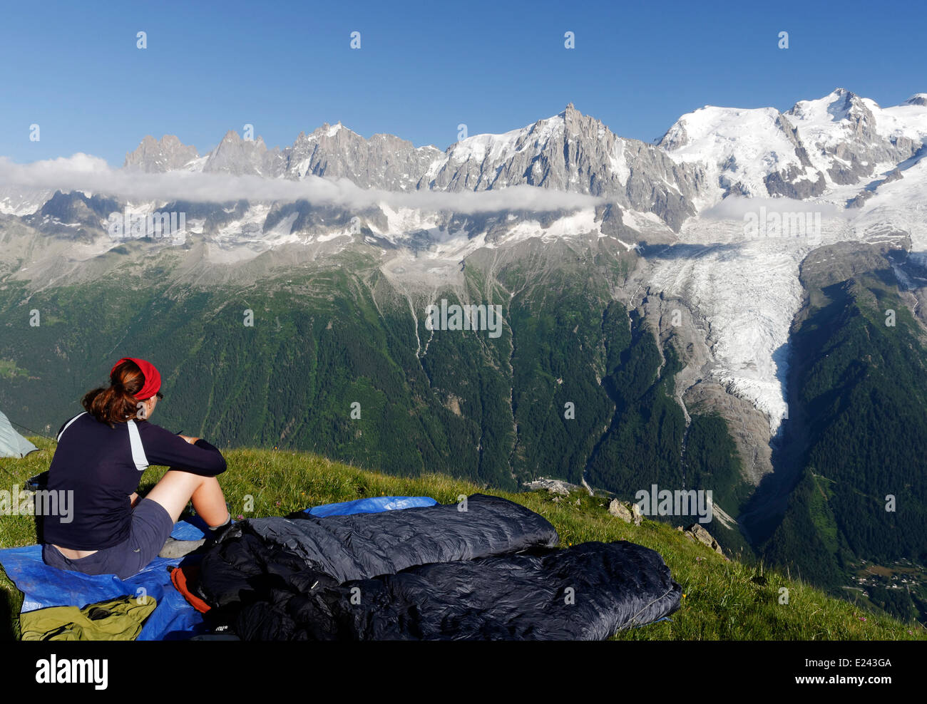 A woman admires the view wild camping on le Brevent in the French Alps ...