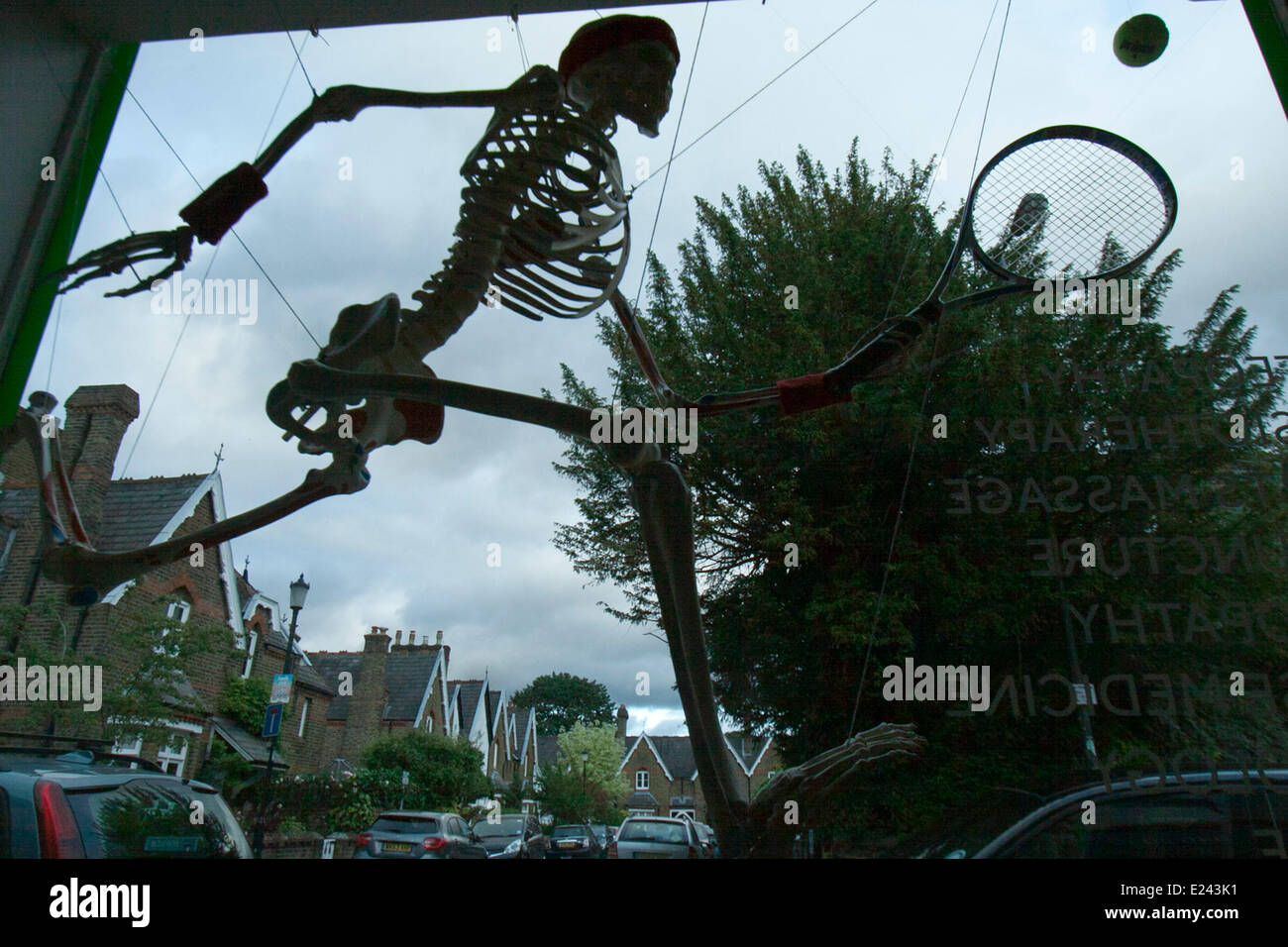 Wimbledon London, UK. 15th June 2014 A human skeleton holding a tennis ...