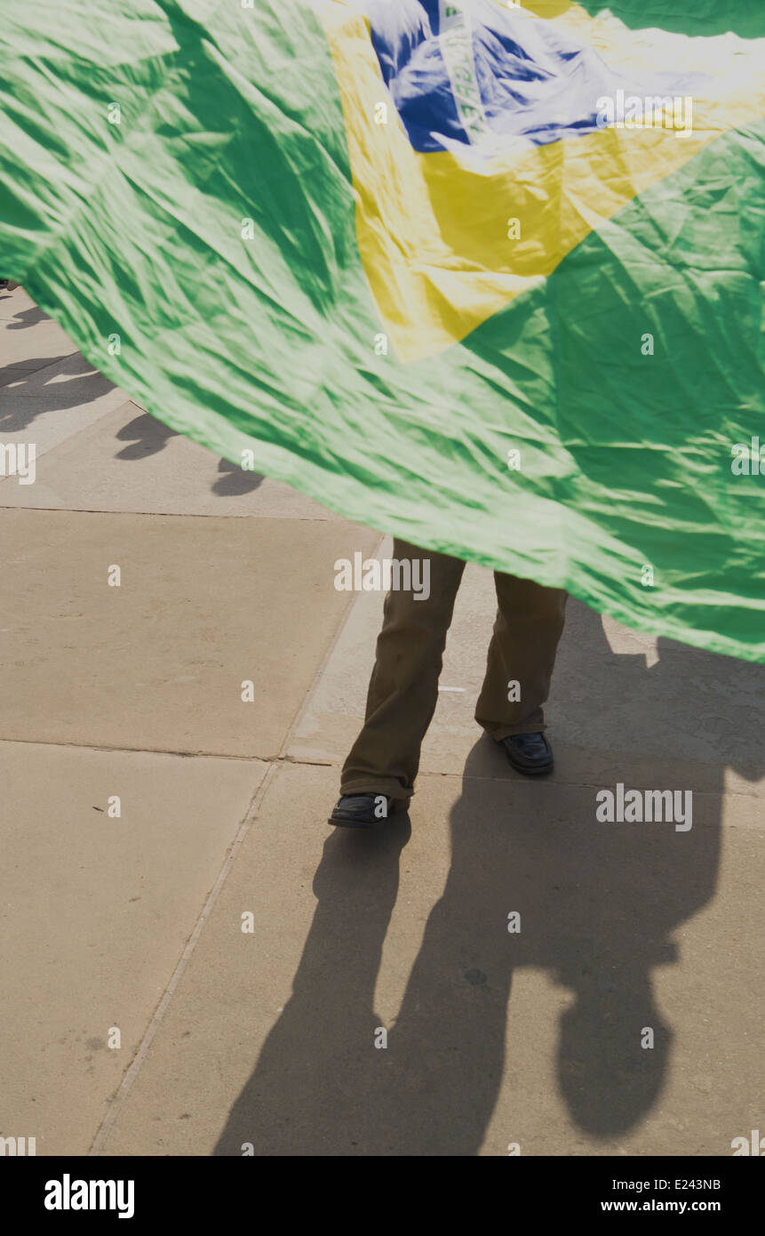 A man waves the Brazilian flag during the Brazil Day celebrations in ...