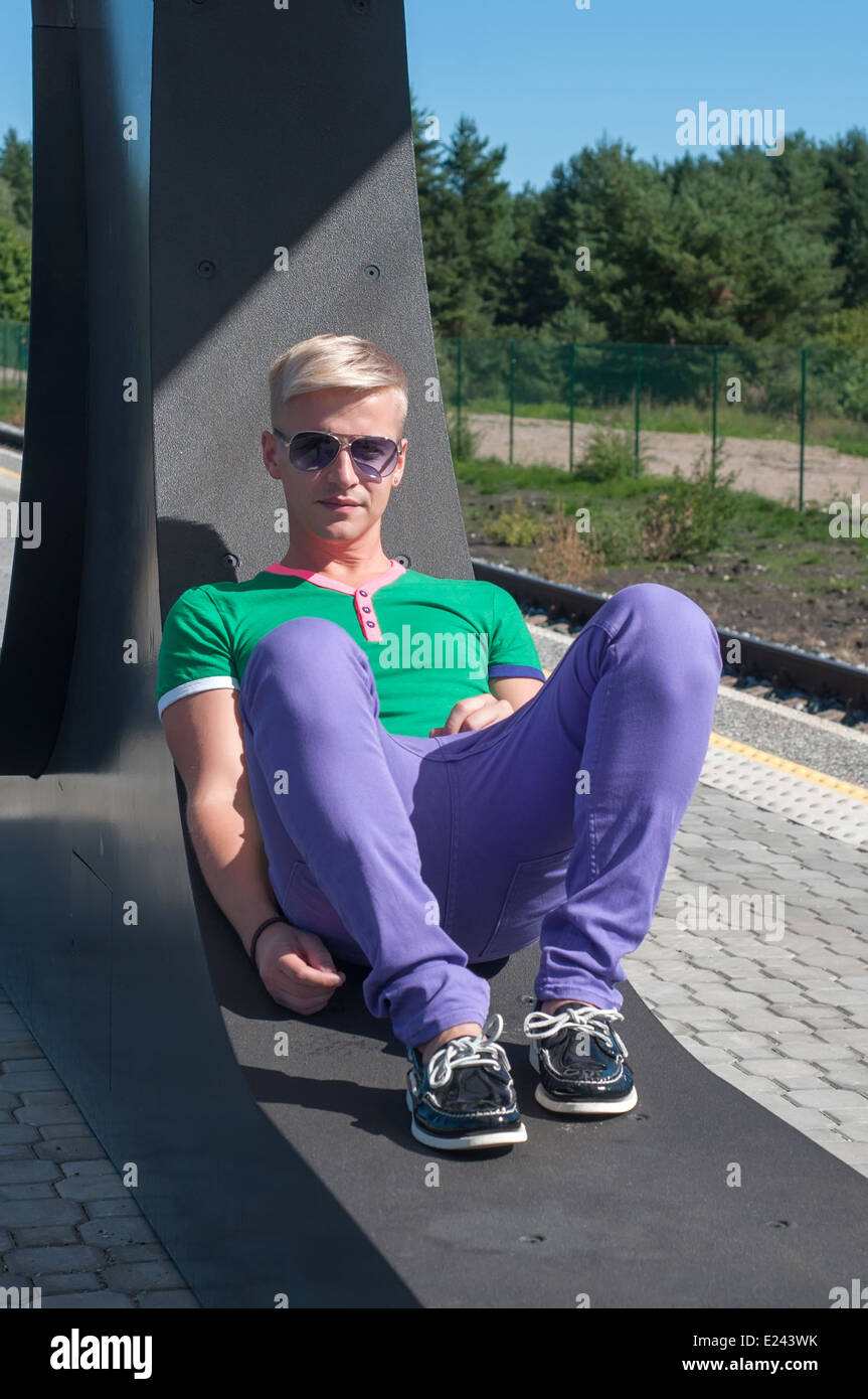 Handsome man sitting on the seat Stock Photo - Alamy