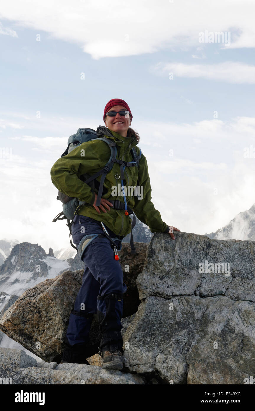 A lady climber on the summit of the Aiguille de Tour in the French Alps ...