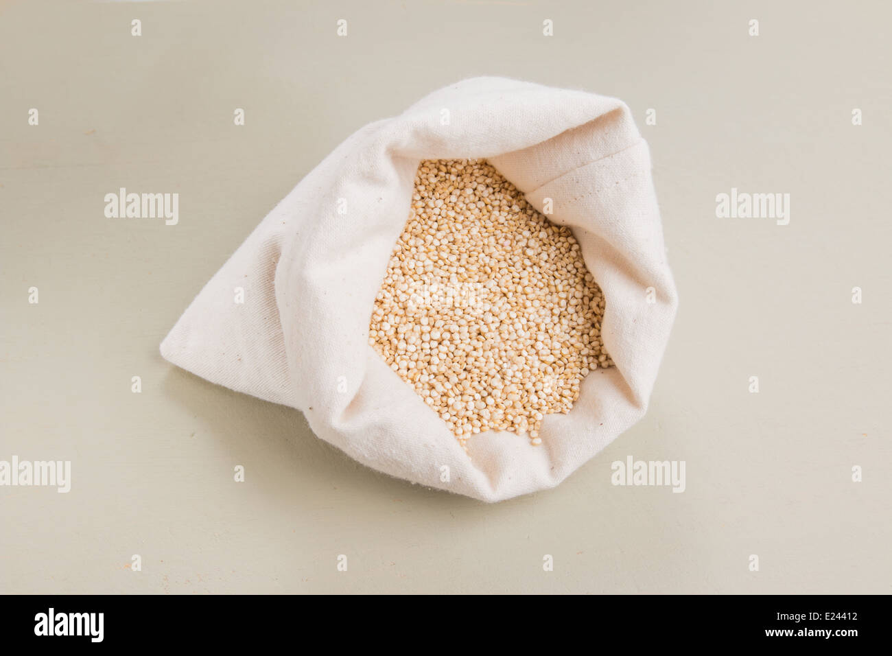 Quinoa seeds in a cream bag on a pale green background "cut out" co(7of ...