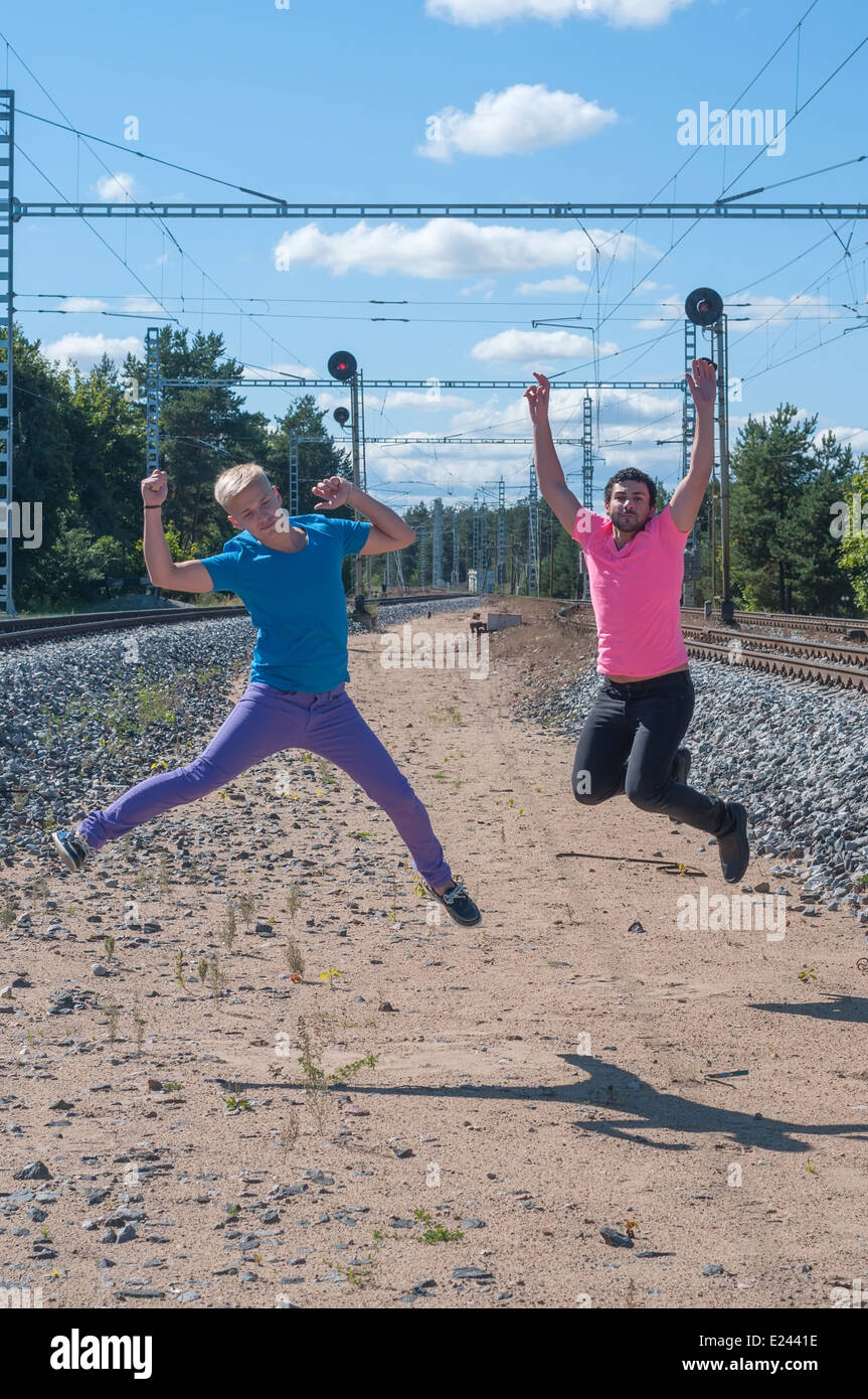 Two handsome young guys jumping Stock Photo - Alamy