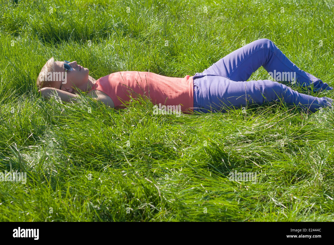Young trendy man lying on the grass Stock Photo - Alamy