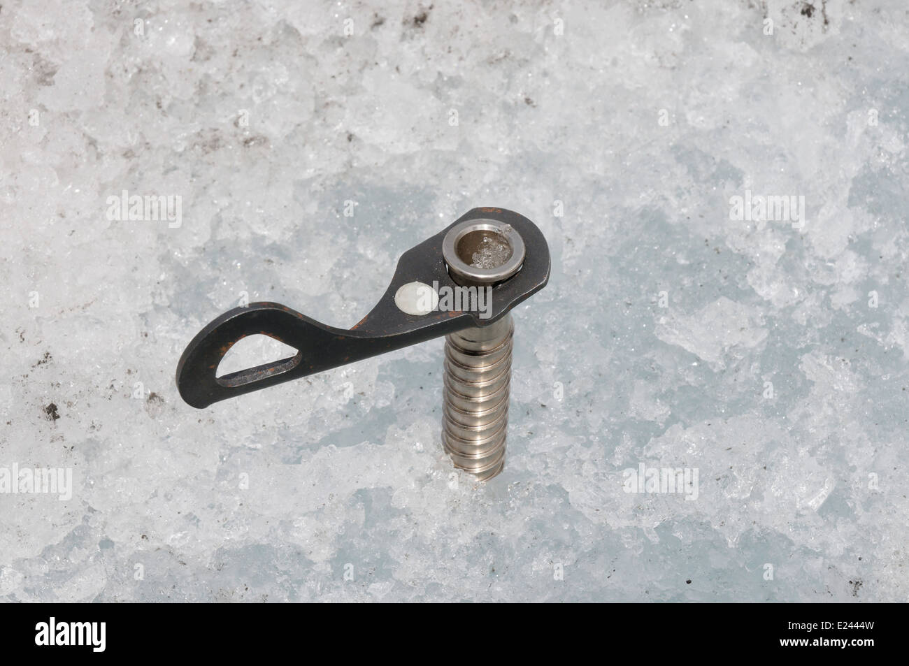 A ice screw in ice on a glacier Stock Photo - Alamy