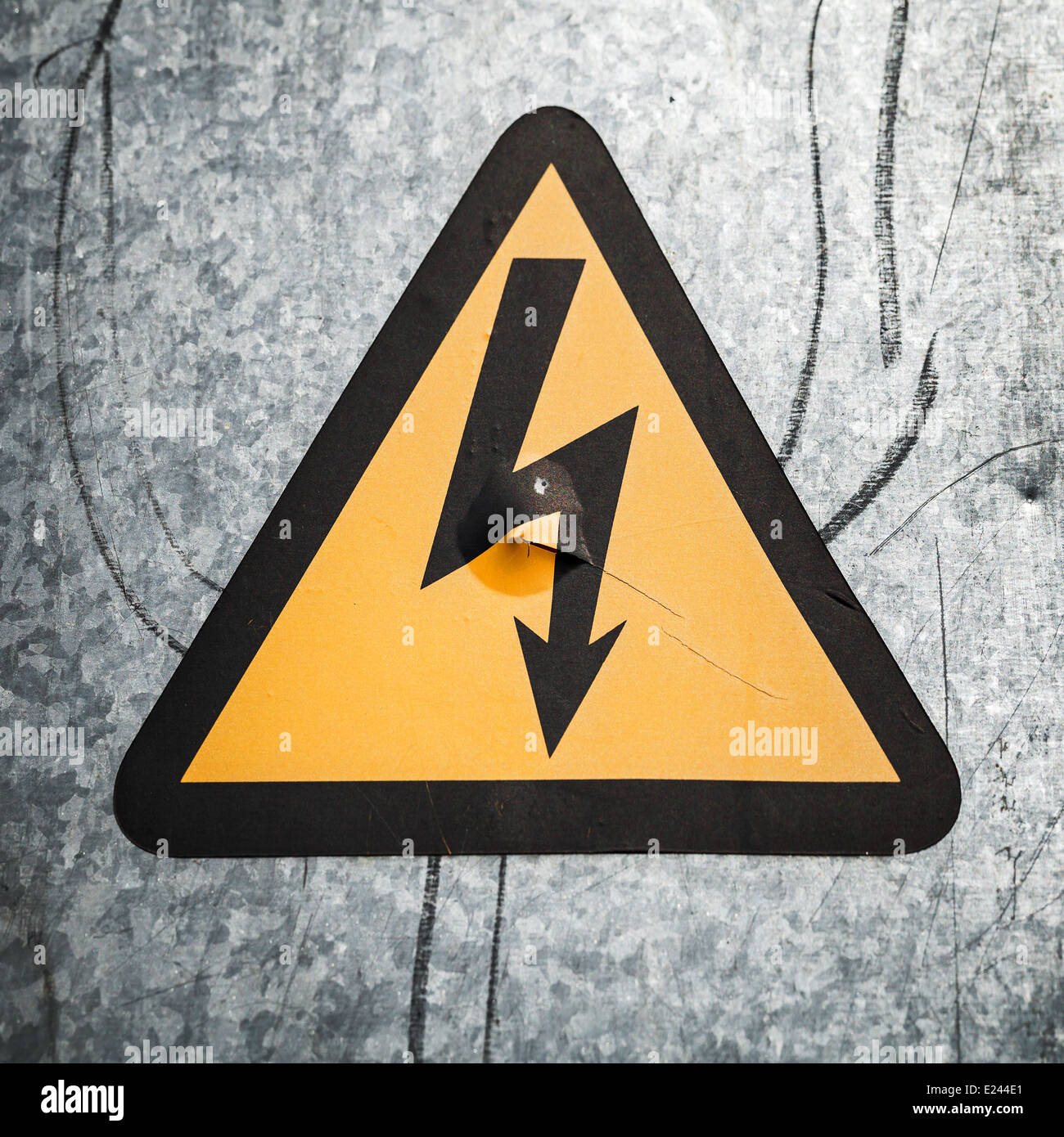 High voltage triangle sign mounted on gray metal wall Stock Photo - Alamy
