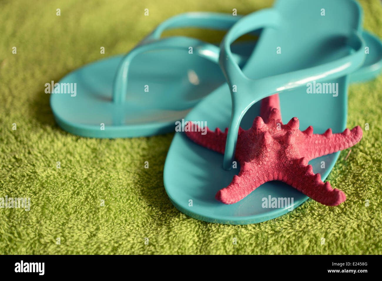 Vacation Concept. Blue Flip-flops with red starfish on towel closeup ...