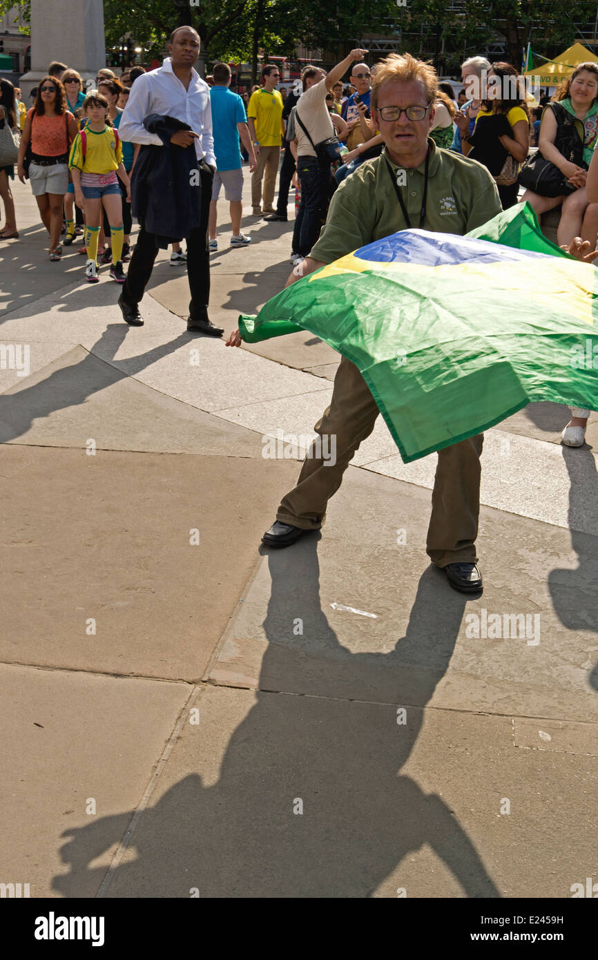 A man waves a Brazilian flag during the Brazil Day celebrations in ...