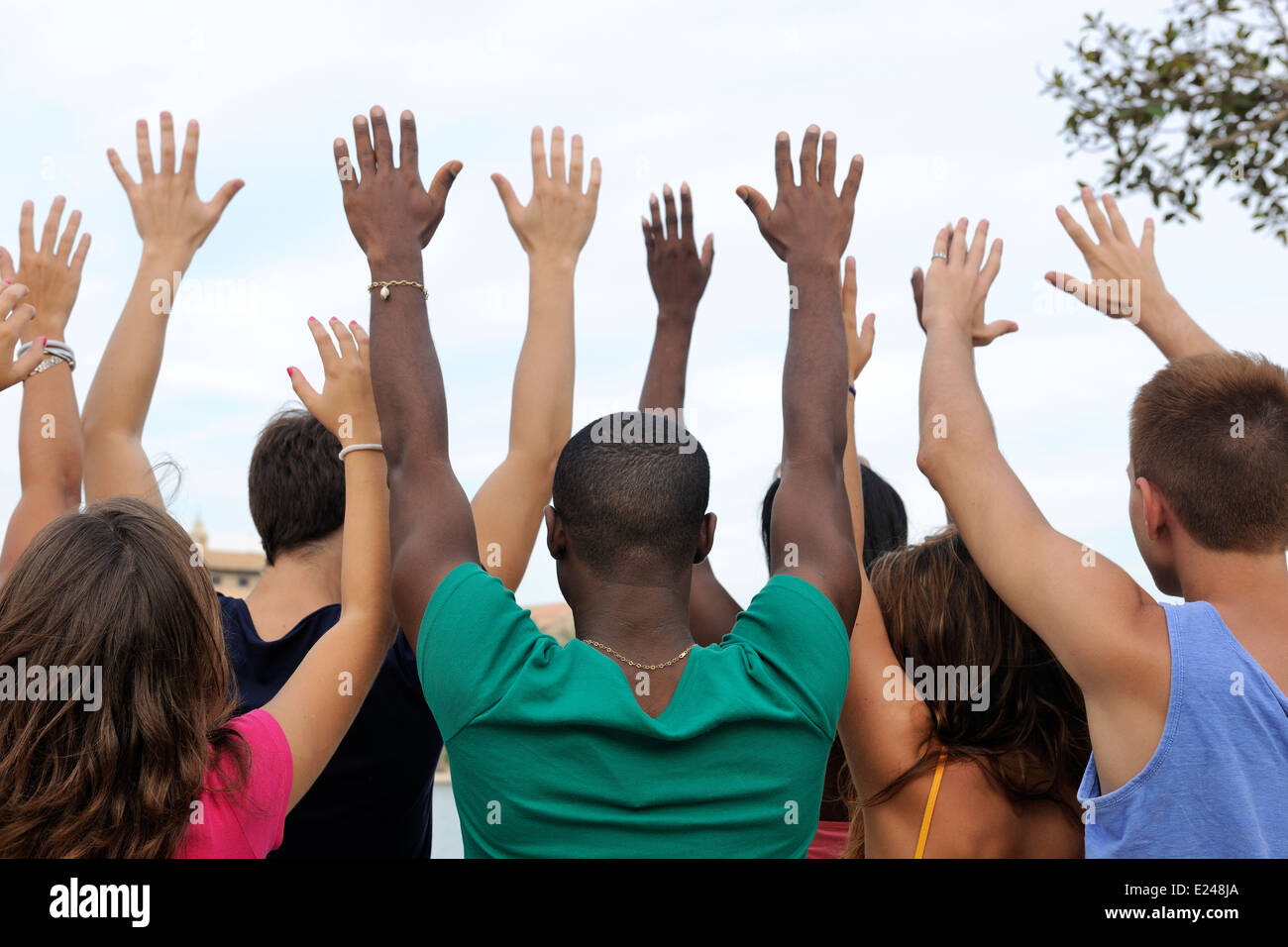 Diverse volunteer group raising hands Stock Photo - Alamy