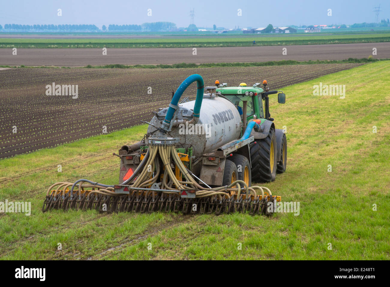 a tractor with a manure injector at a grassland Stock Photo - Alamy