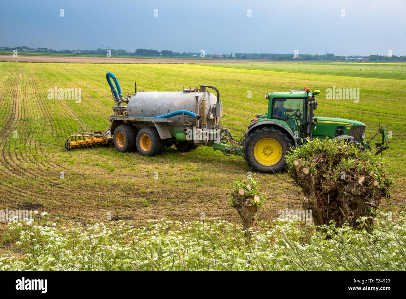 a tractor with a manure injector at a grassland Stock Photo - Alamy
