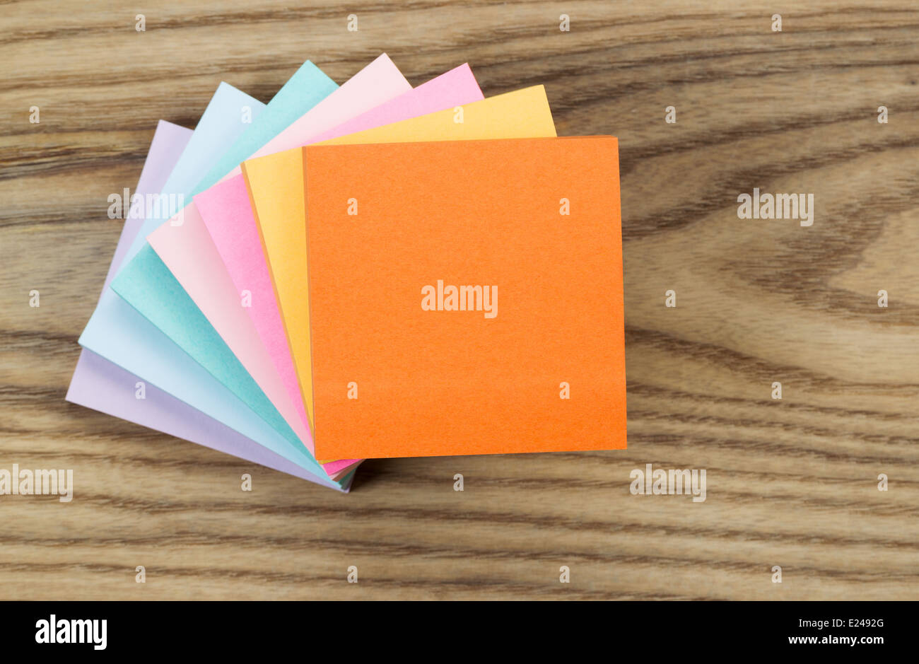 Overhead view of a stack of multi-color paper sticky notes placed on ...