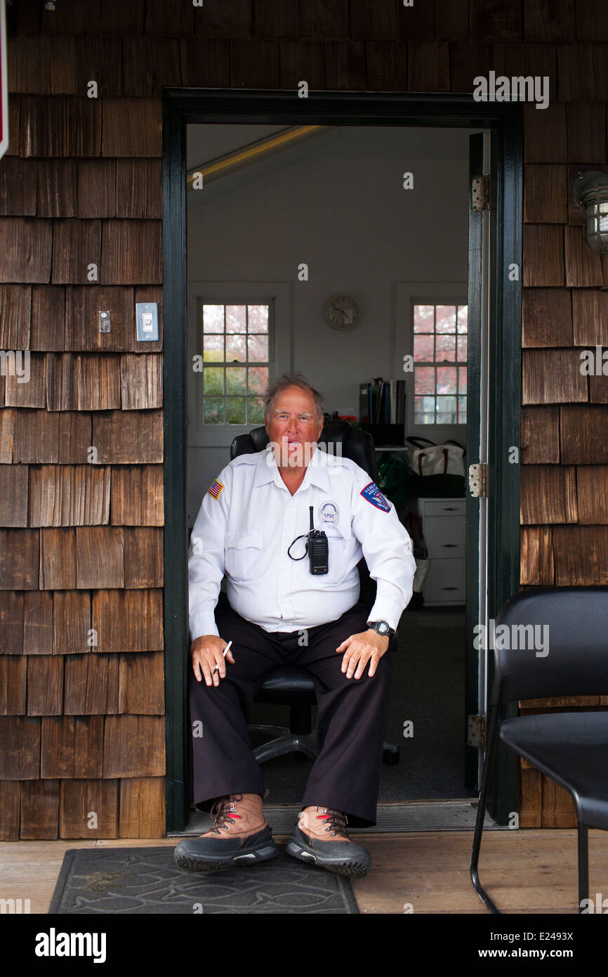 A security guard sits at a guard shack at the entrance to Newport ...