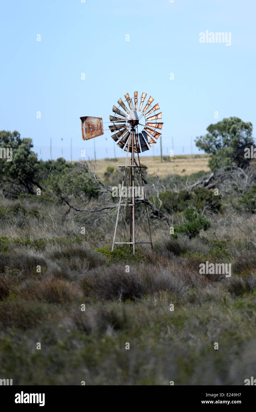 A rusty old windmill in an open field Stock Photo - Alamy