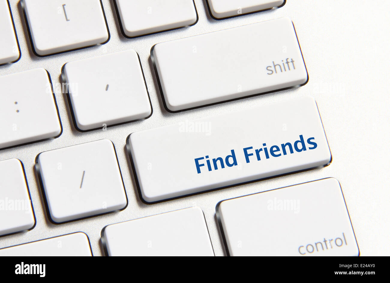 Photo of find friends button on the white keyboard Stock Photo - Alamy