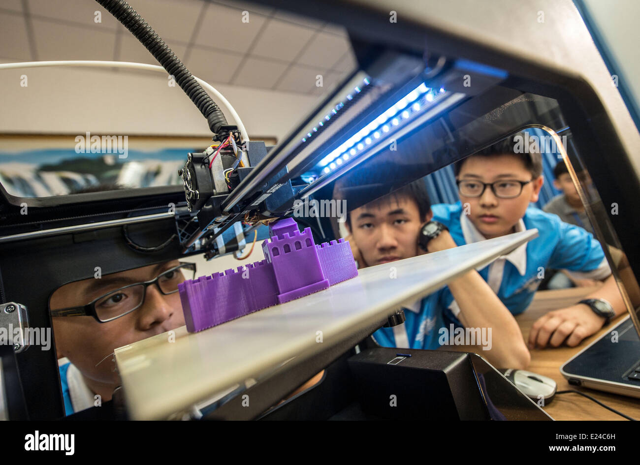 Beijing, China. 16th June, 2014. Students view a 3D printer at the 3D ...