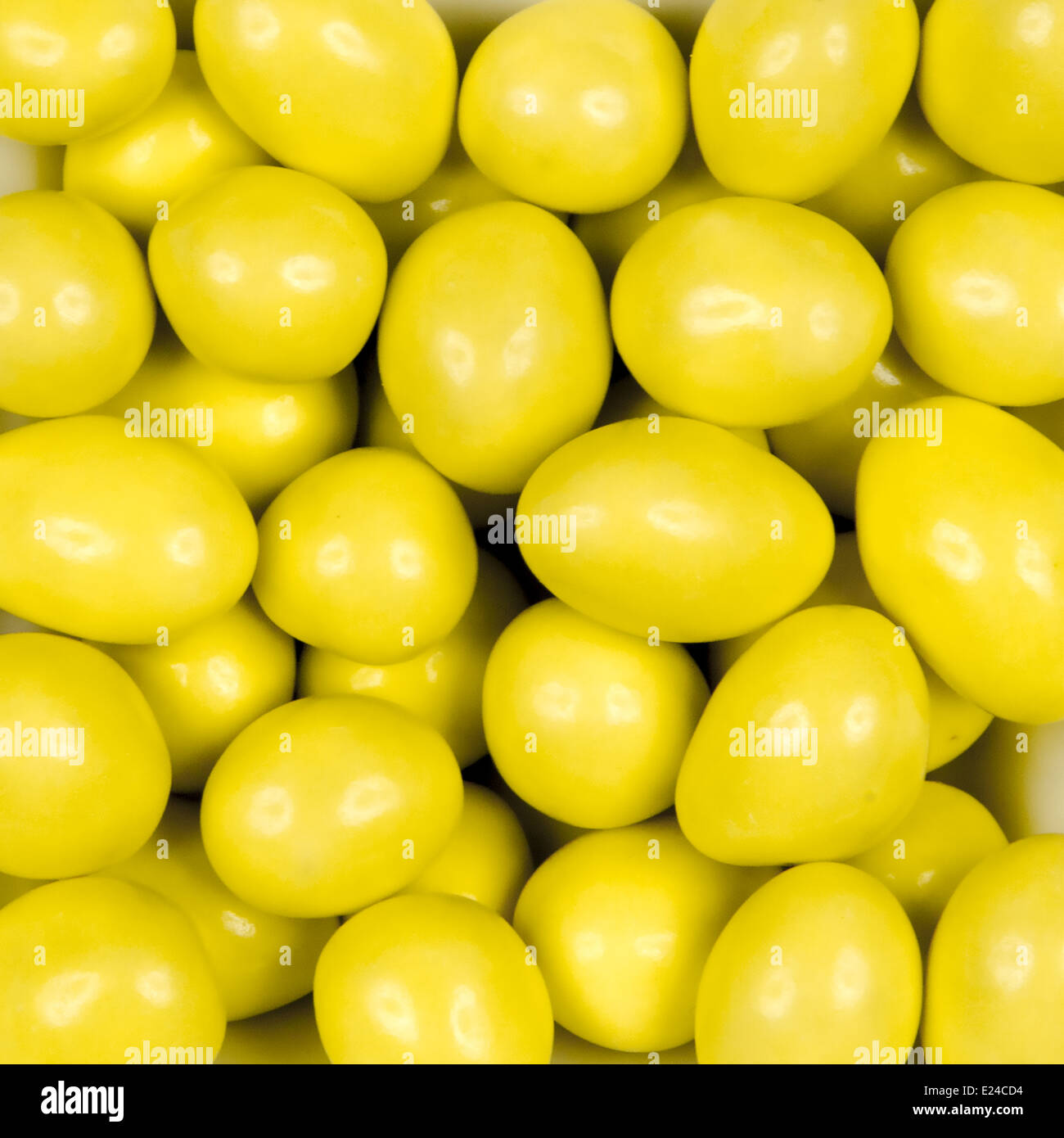 a background of peanuts covered with yellow chocolate Stock Photo - Alamy