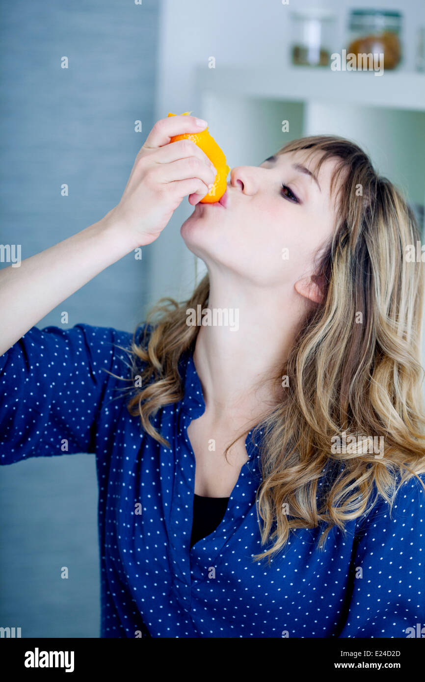 Woman eating fruit Stock Photo - Alamy