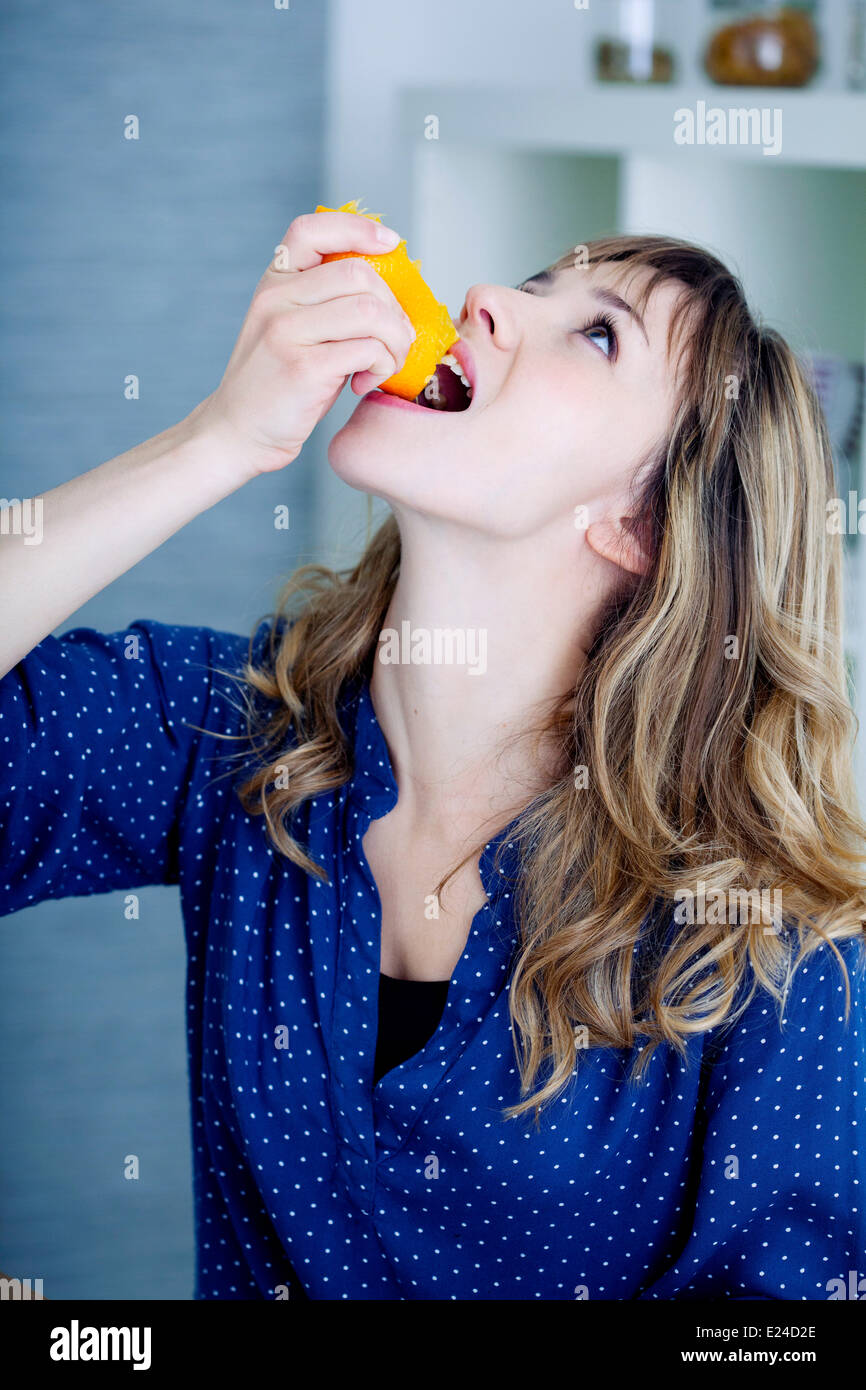Woman eating fruit Stock Photo - Alamy